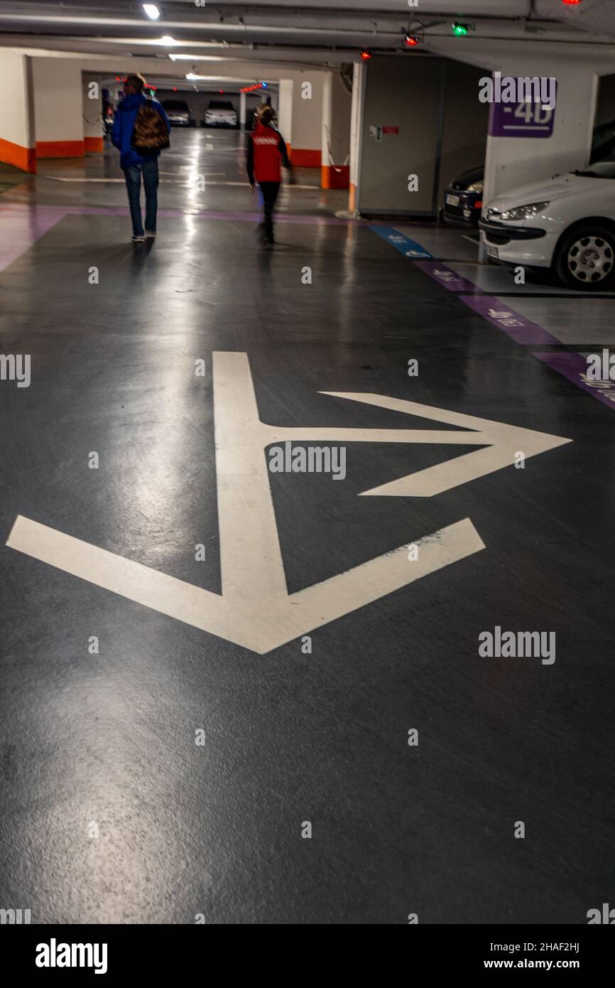 arrow signs painted onto a car park floor Stock Photo - Alamy