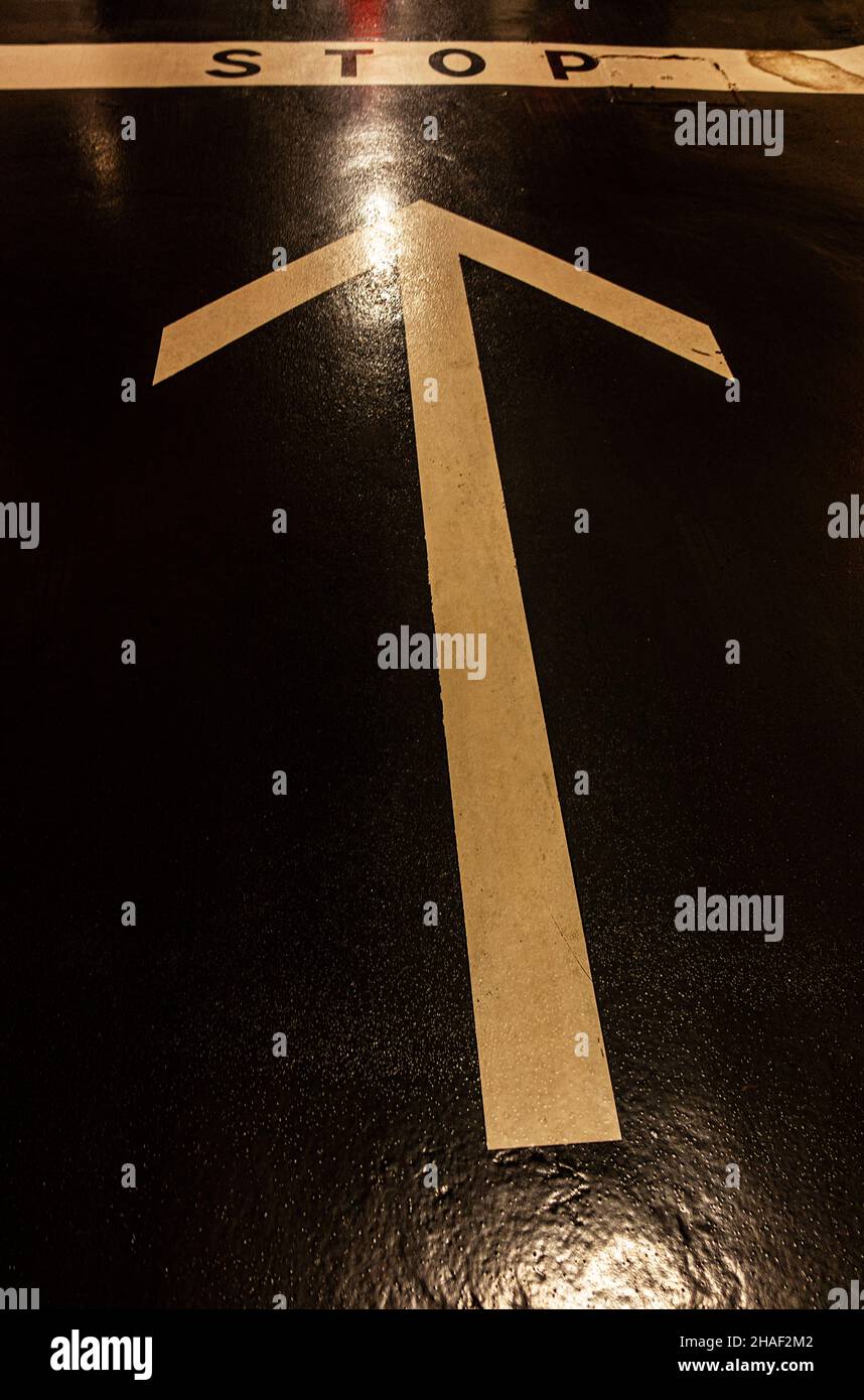 straight on arrow sign on the floor of an indoor car park Stock Photo ...