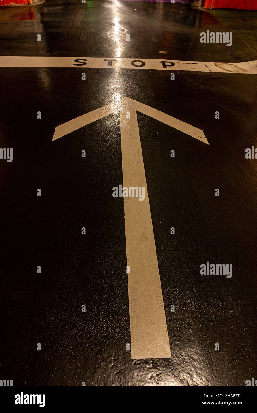 straight on arrow sign on the floor of an indoor car park Stock Photo ...