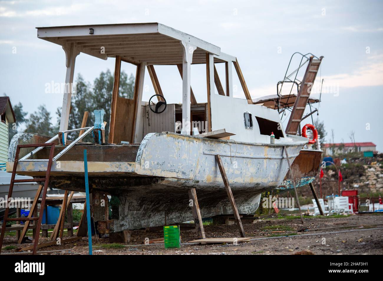 A boat landed for repair Stock Photo - Alamy