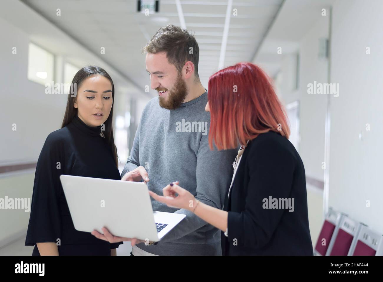 Group of students having a conversation inside of modern university ...