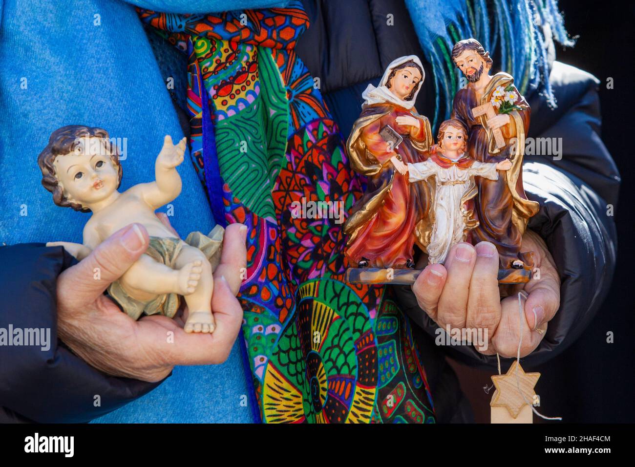 A devotee holds a statuette of the baby Jesus during the Sunday Angelus ...
