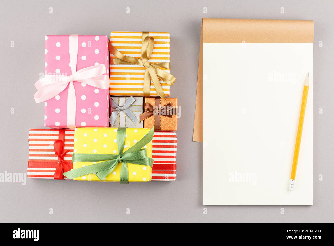Presents in colored paper with an open notebook Stock Photo - Alamy