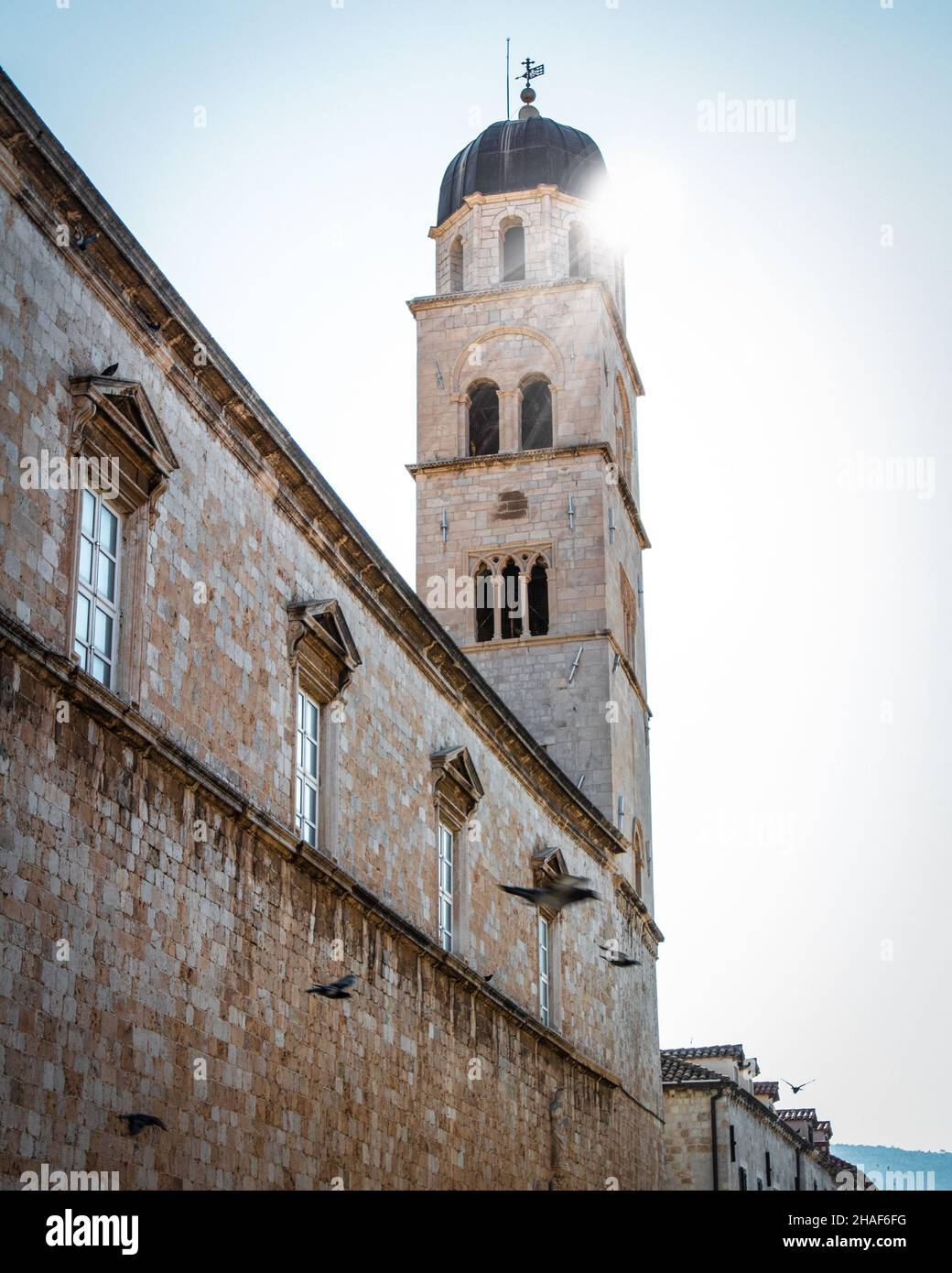 The tower of Franciscan Church and Monastery, light rays peered around ...
