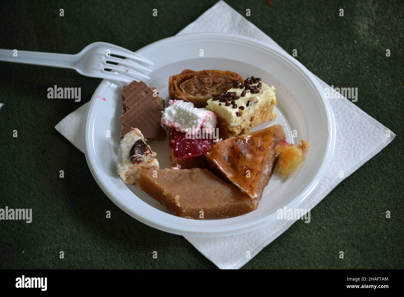A lot of different sweets in a plastic one-time used plate Stock Photo ...