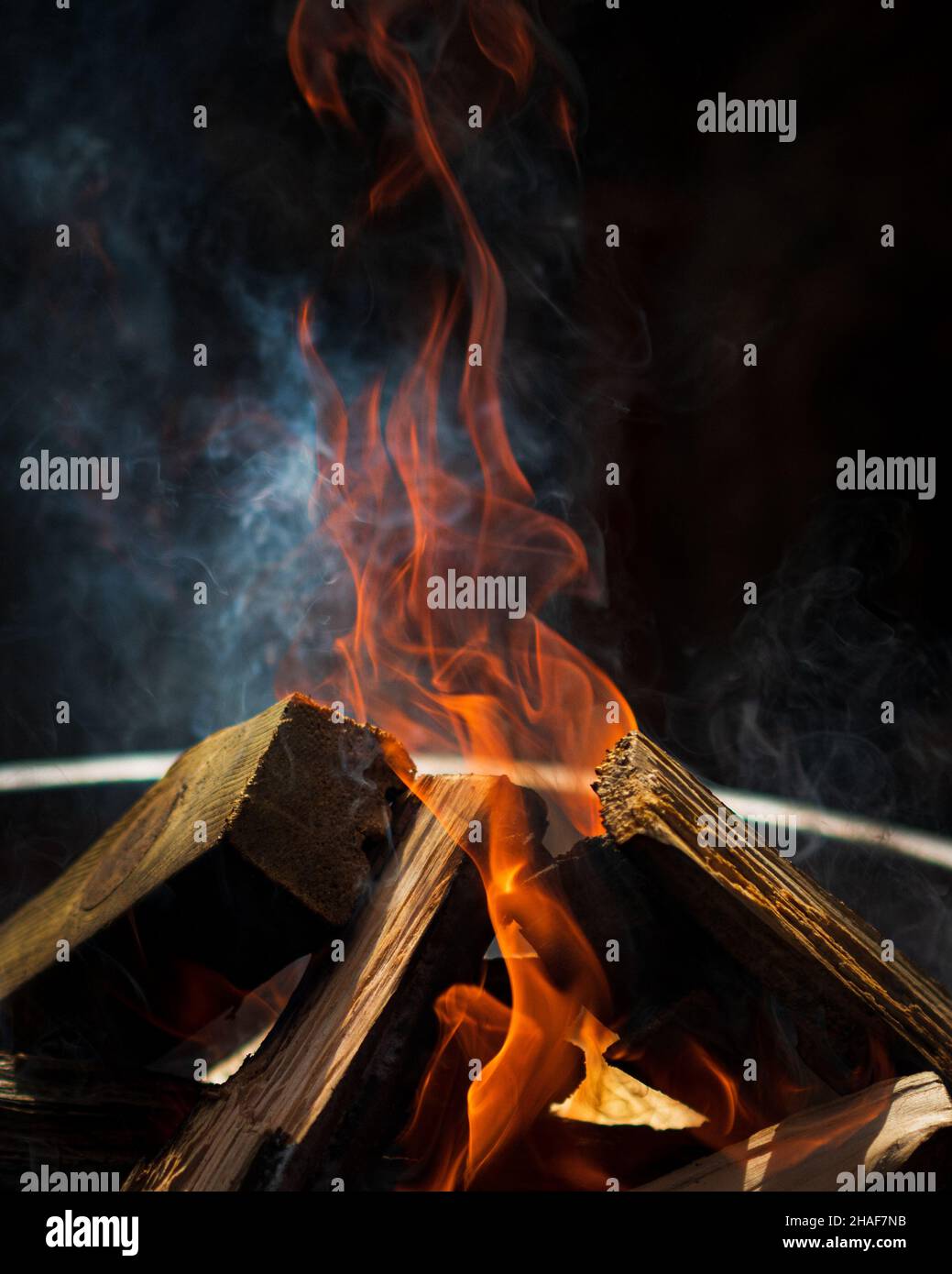 A pile of wood sticks burning Stock Photo - Alamy
