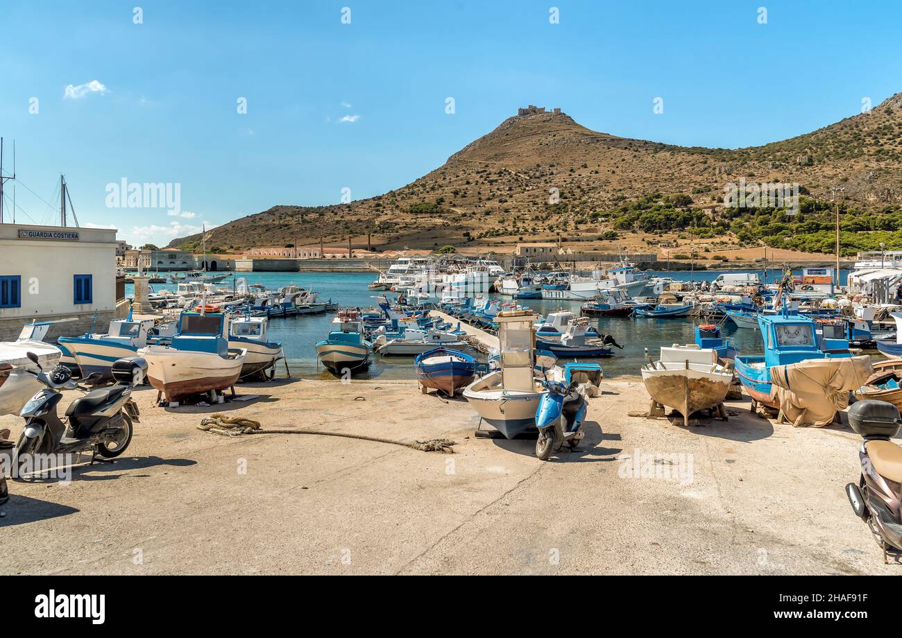 View of the Favignana island harbor with traditional fishing boats ...