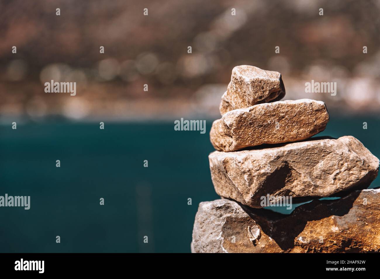 A stack of stones arranged on each other in the blurred background with ...