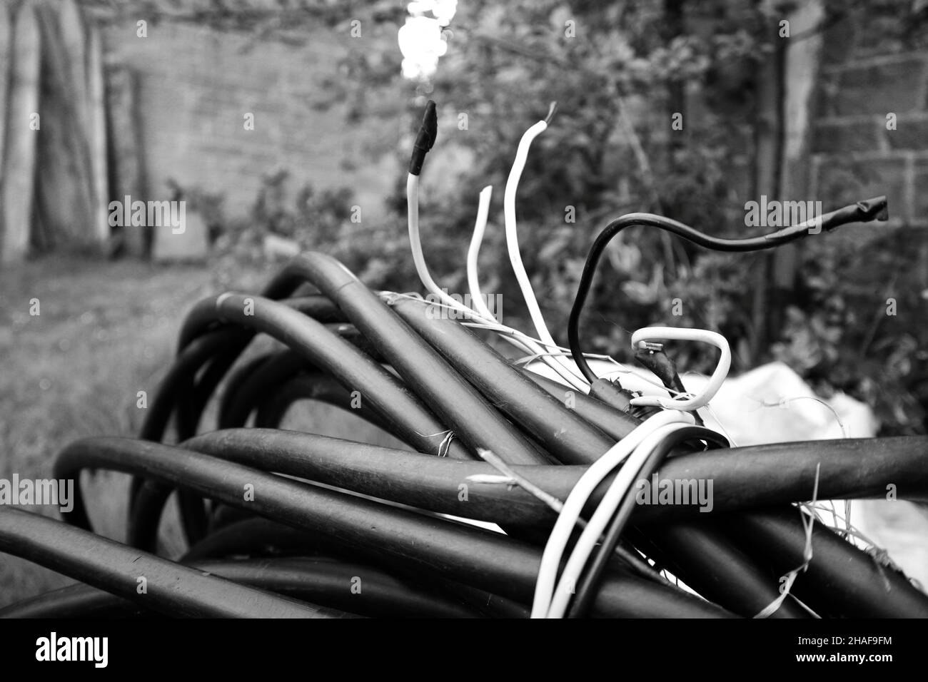 black and white photo of a bundle of electrical cables in a stone yard ...