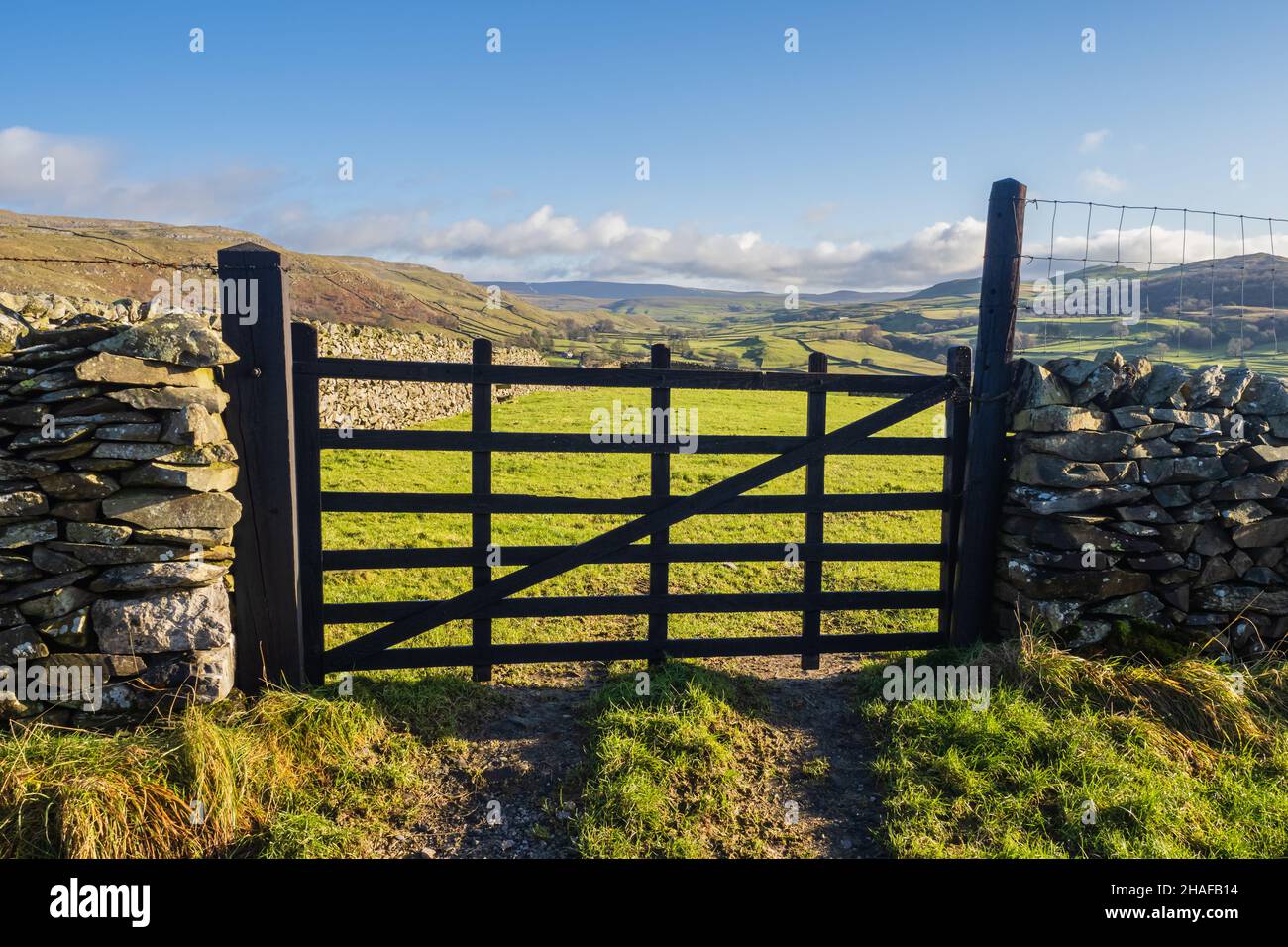 Six bar gate headsing into a green pasture above austwick in the ...