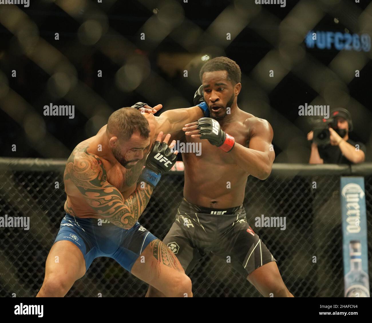 LAS VEGAS, NV - DECEMBER 11: (L-R) Santiago Ponzinibbio punches Geoff ...