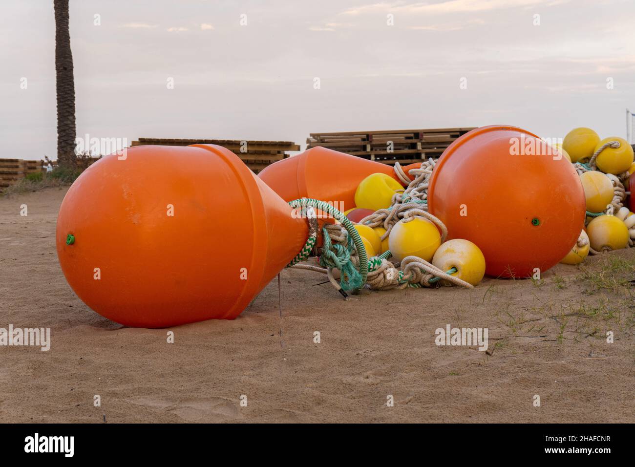 A close-up shot of buoys of different sizes and colors thrown in the ...