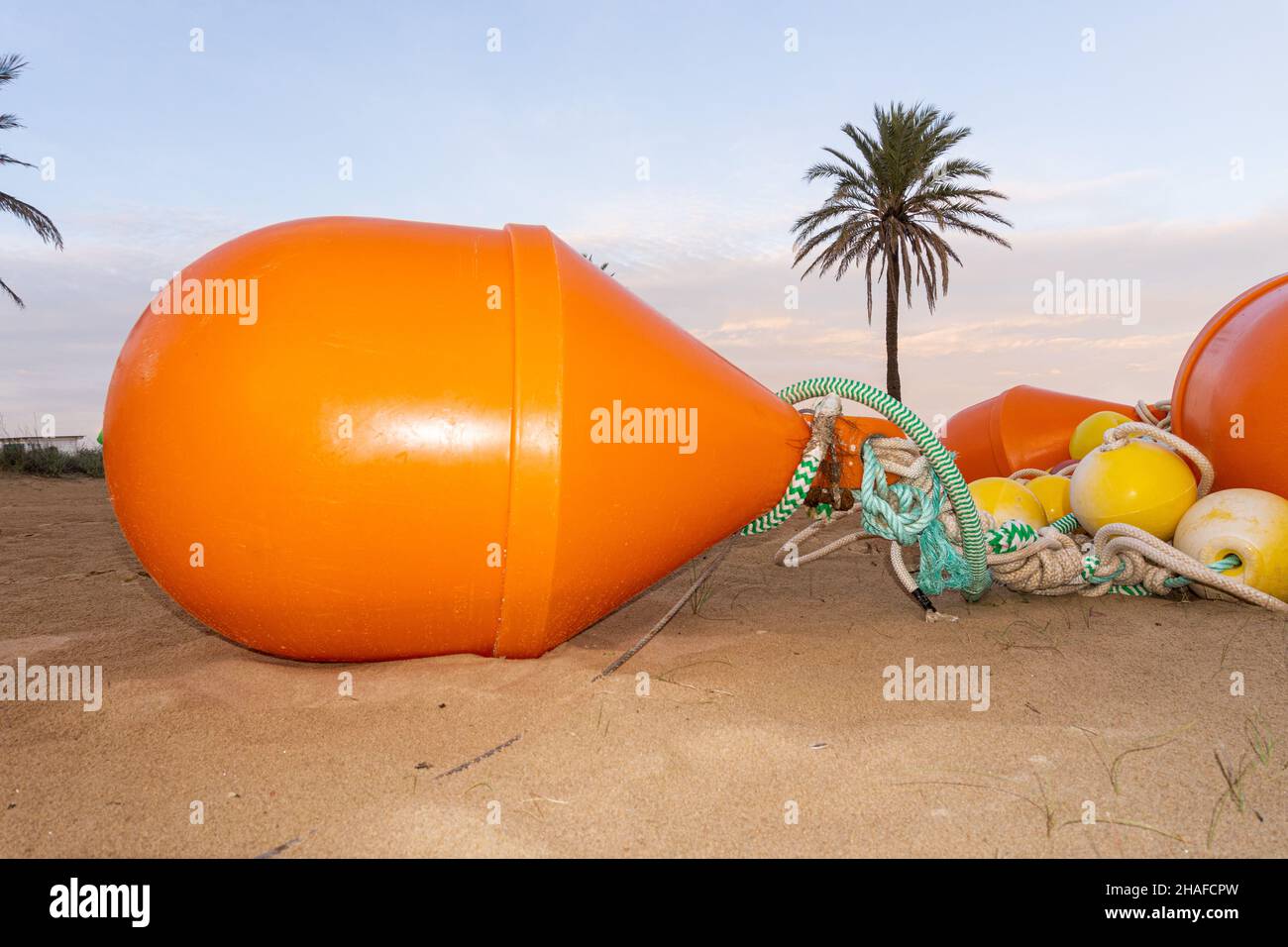 A close-up shot of buoys of different sizes and colors thrown in the ...