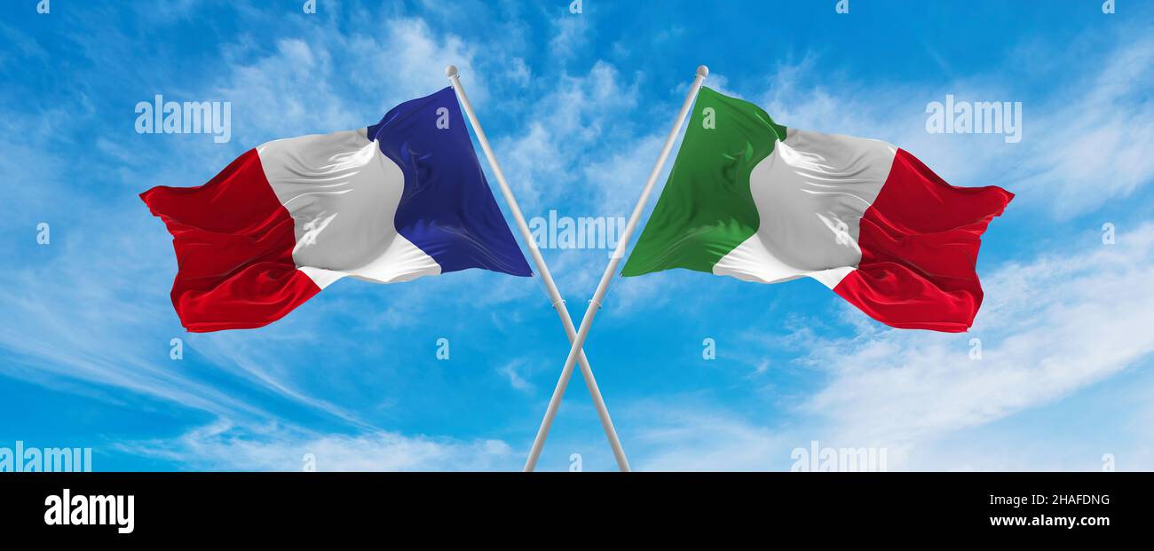 crossed national flags of France and Italia flag waving in the wind at ...