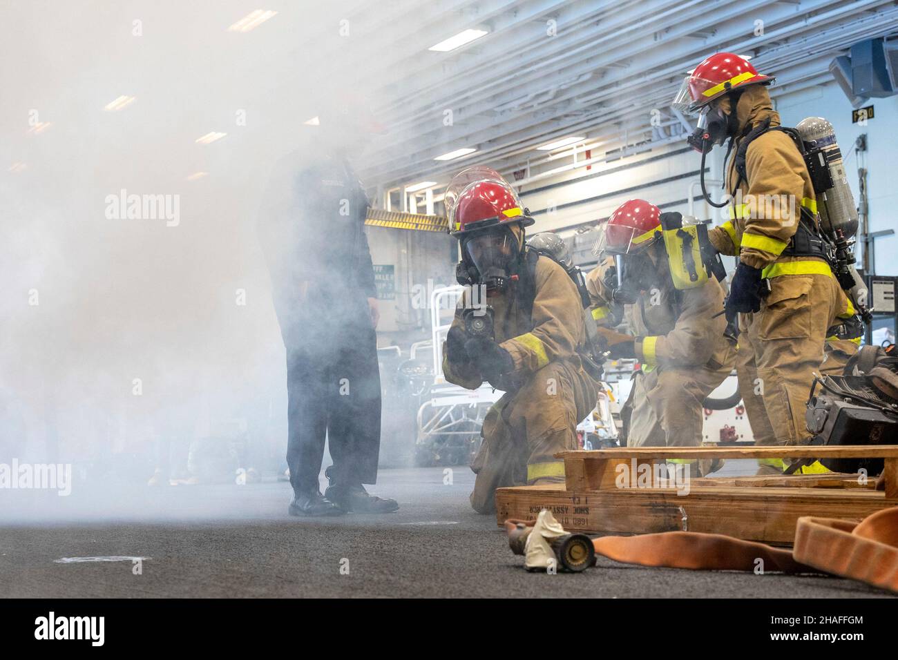 PACIFIC OCEAN (Dec. 11, 2021) – Fireman Anthony Soto simulates spraying ...