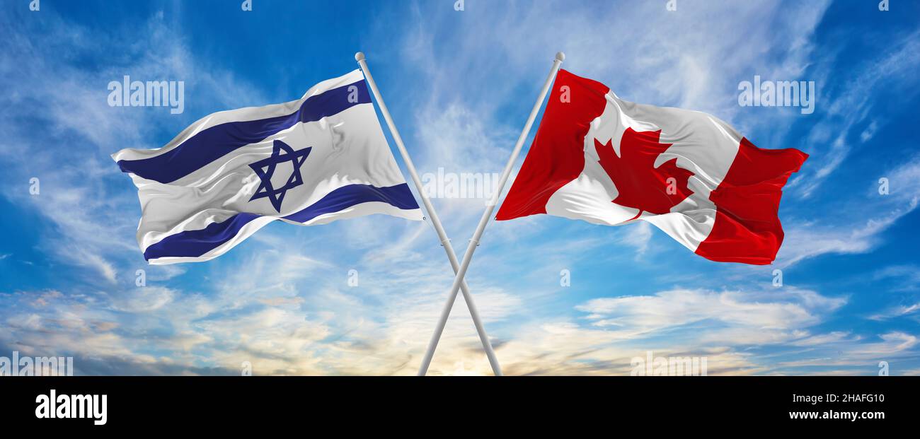 crossed national flags of Israel and canada flag waving in the wind at ...