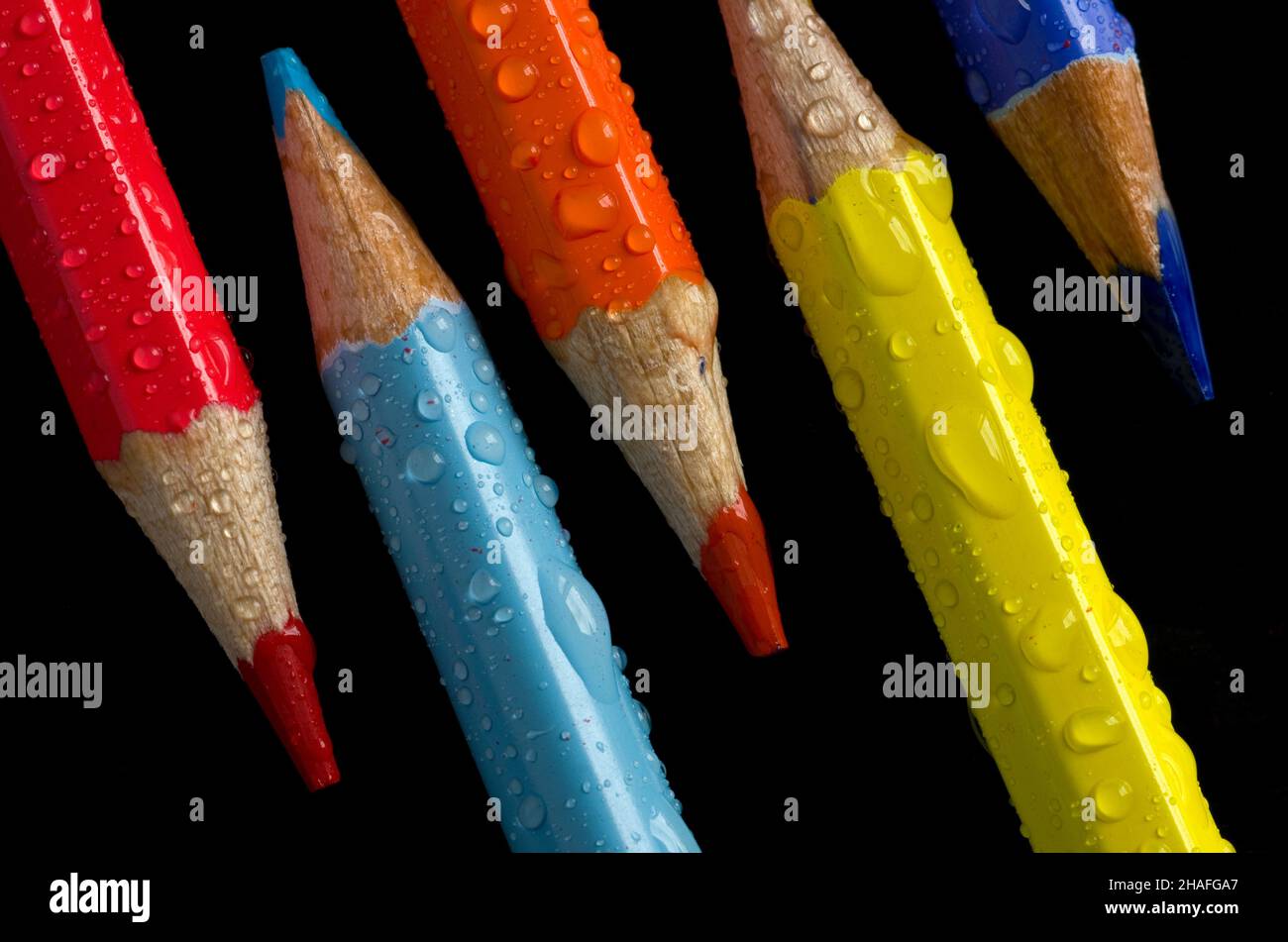 Macro Image of Red,Orange, Blue and Yellow Crayons with Water Droplets ...