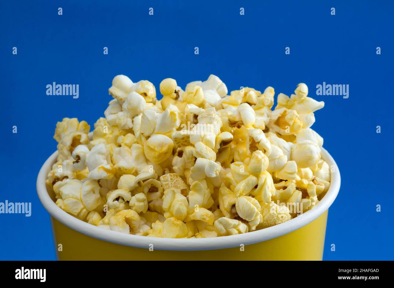 Macro of Yellow Popcorn with Blue Background Horizontal Stock Photo - Alamy