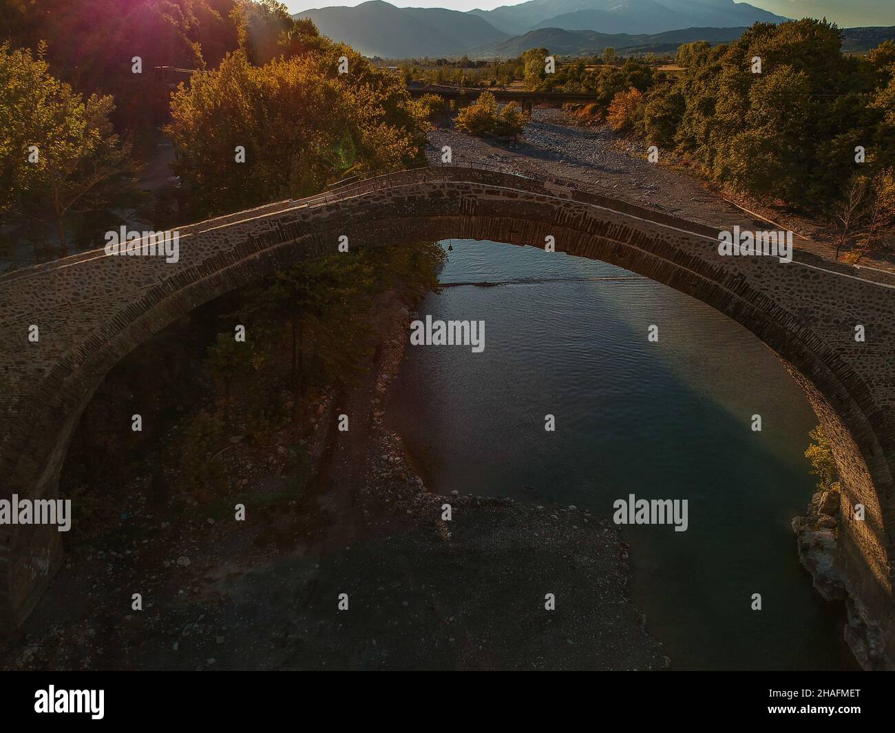 The famous old stoned bridge of Konitsa over Aoos river. Tymfi mount ...