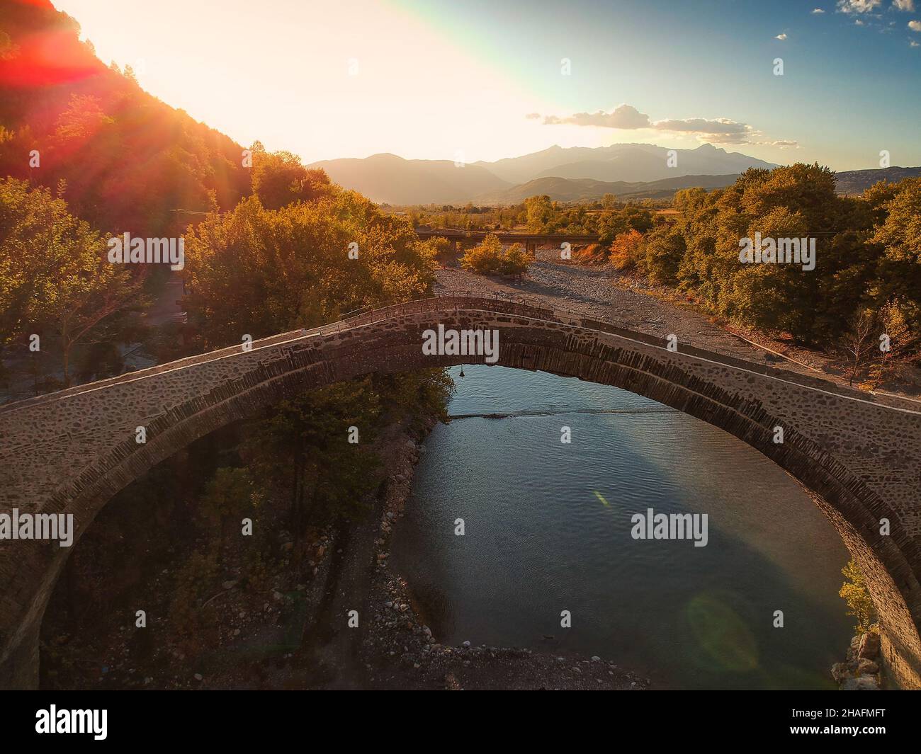 The famous old stoned bridge of Konitsa over Aoos river. Tymfi mount ...