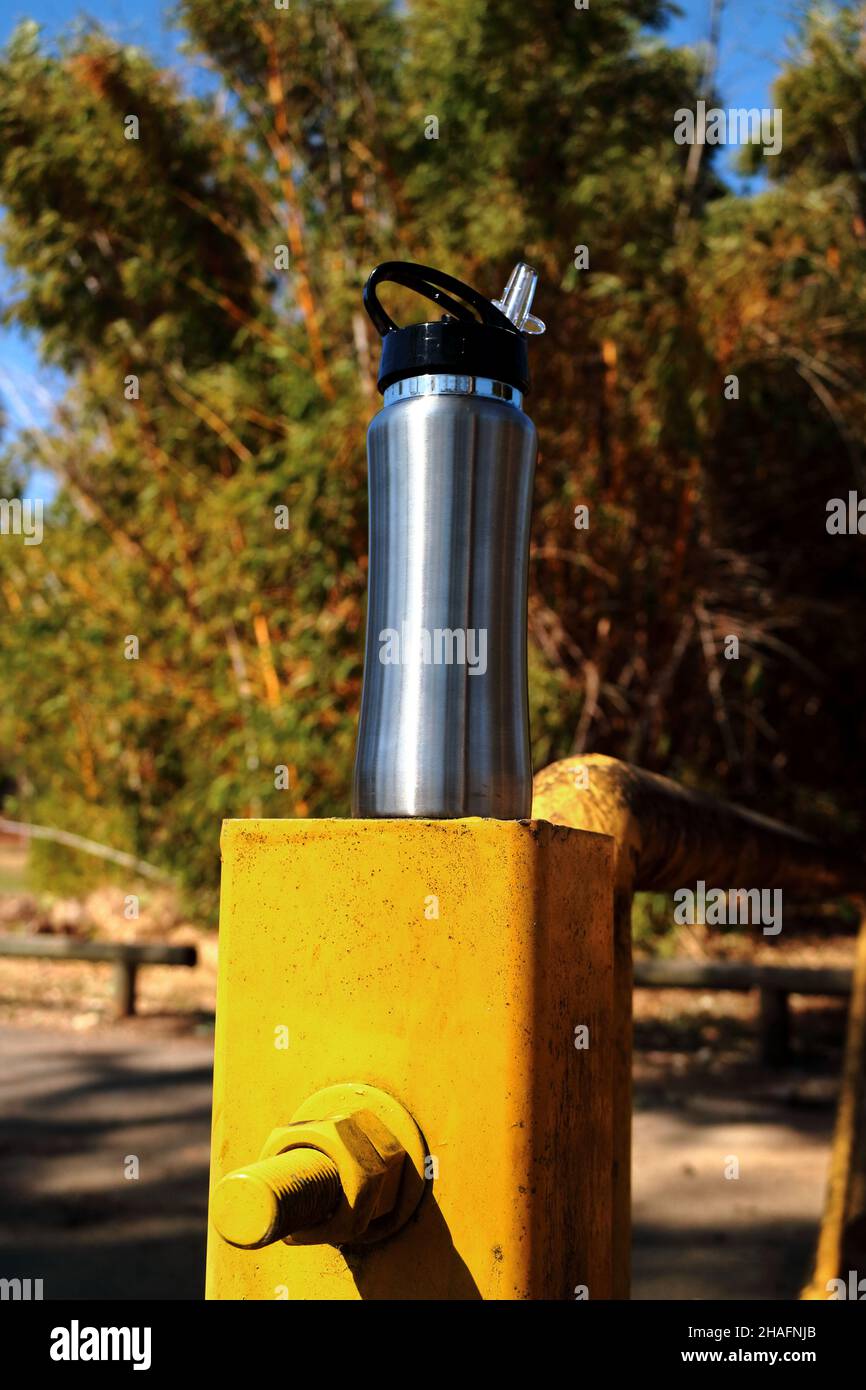 Brand new aluminium water bottle left sitting on a yellow gate post at ...