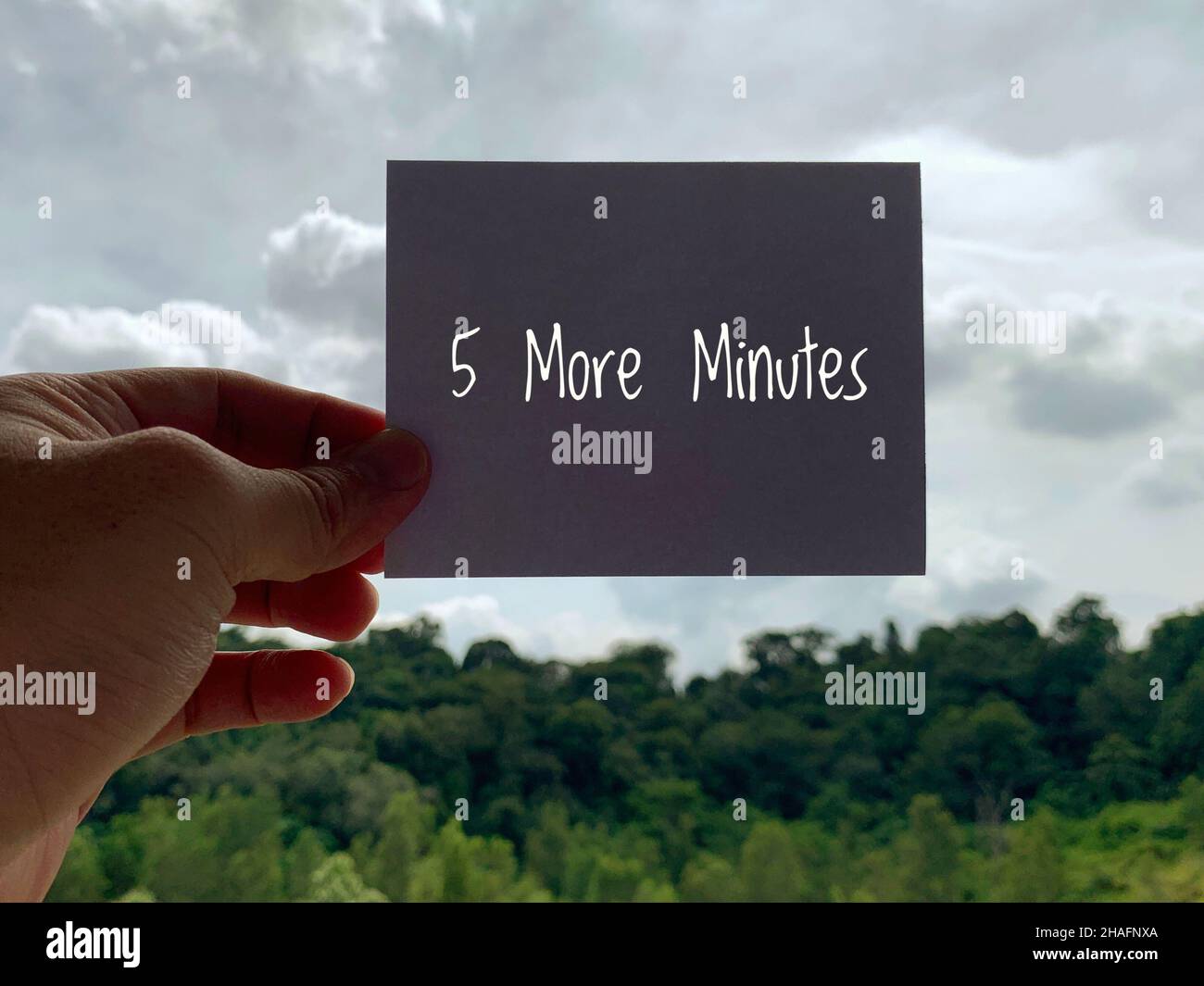 Five more minutes text on a cardboard with hand holding it Stock Photo ...