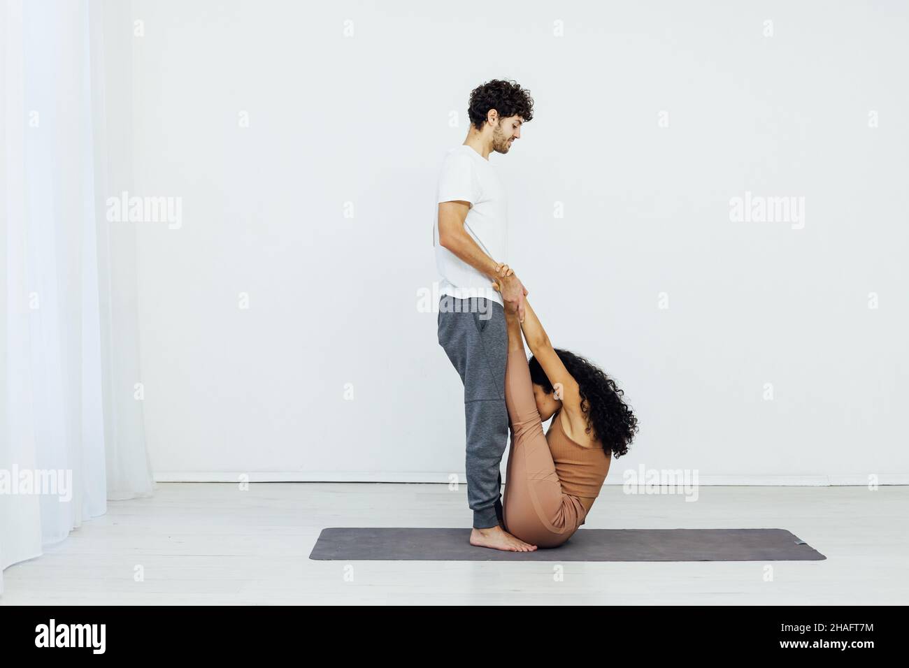 man and woman together doing exercises yoga asana fitness Stock Photo ...