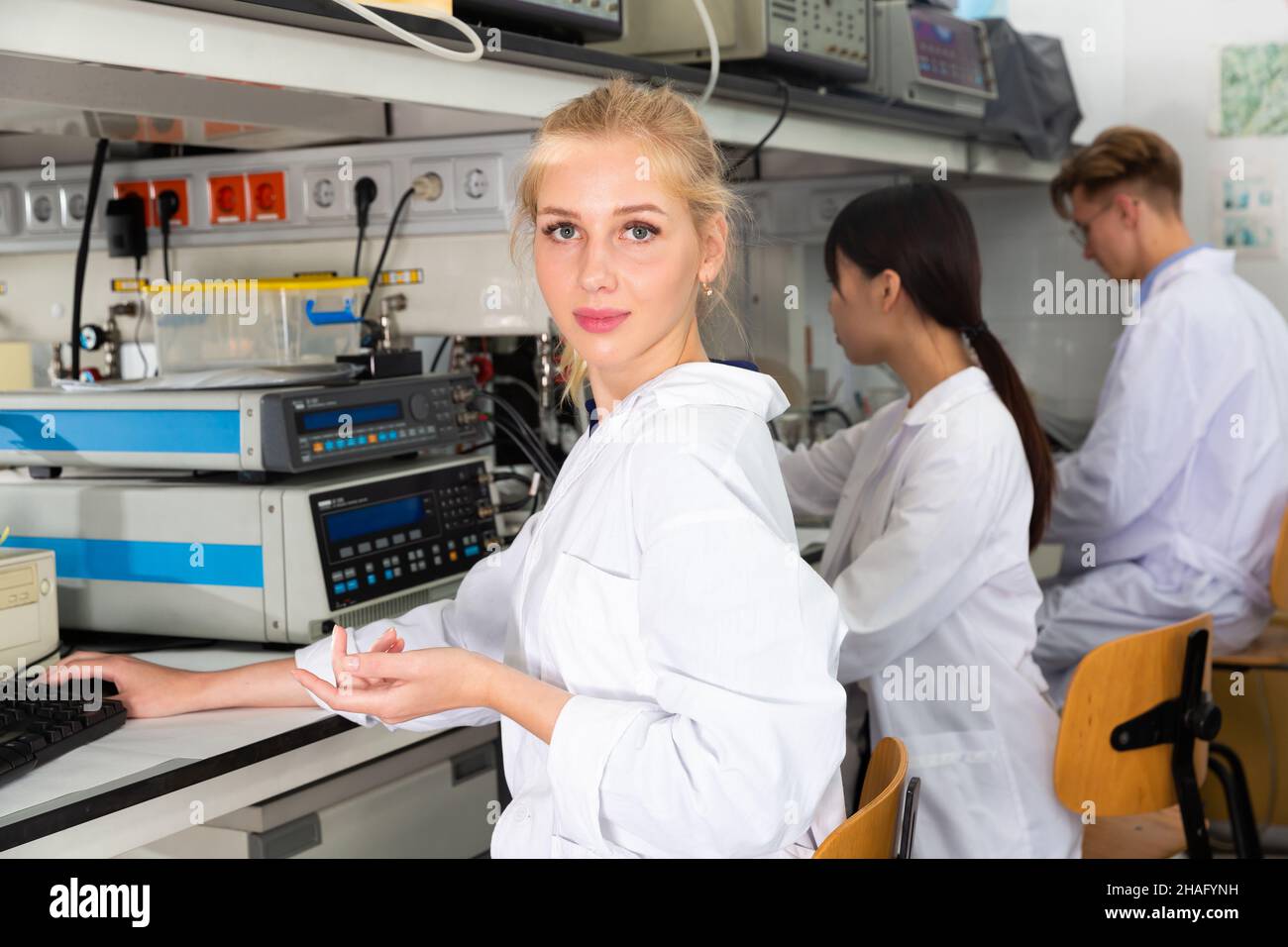 Portrait of male and female scientists in white coats working at biochemical laboratory Stock ...