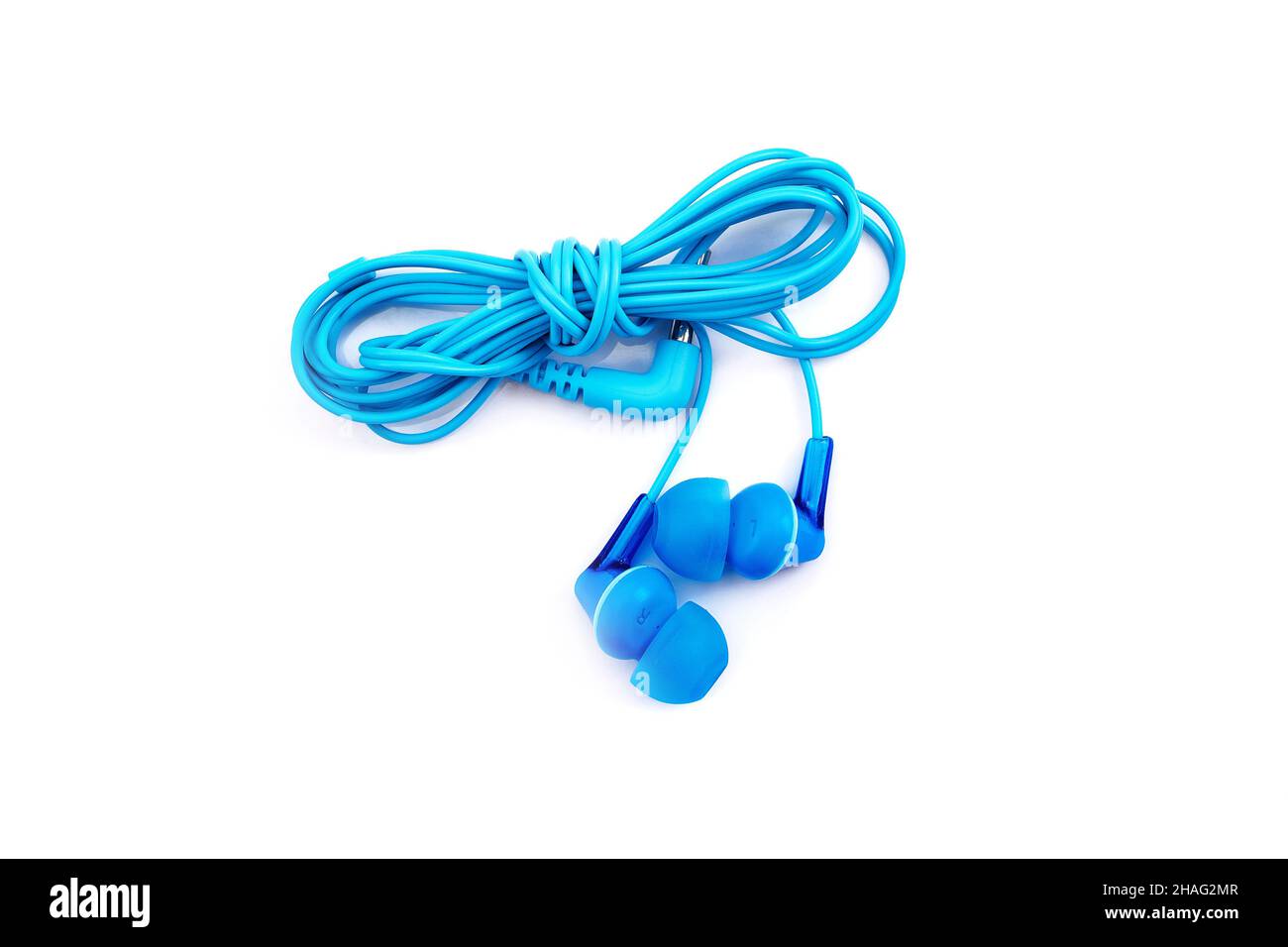 Blue earbuds isolated on white background. Neatly coiled wire ...