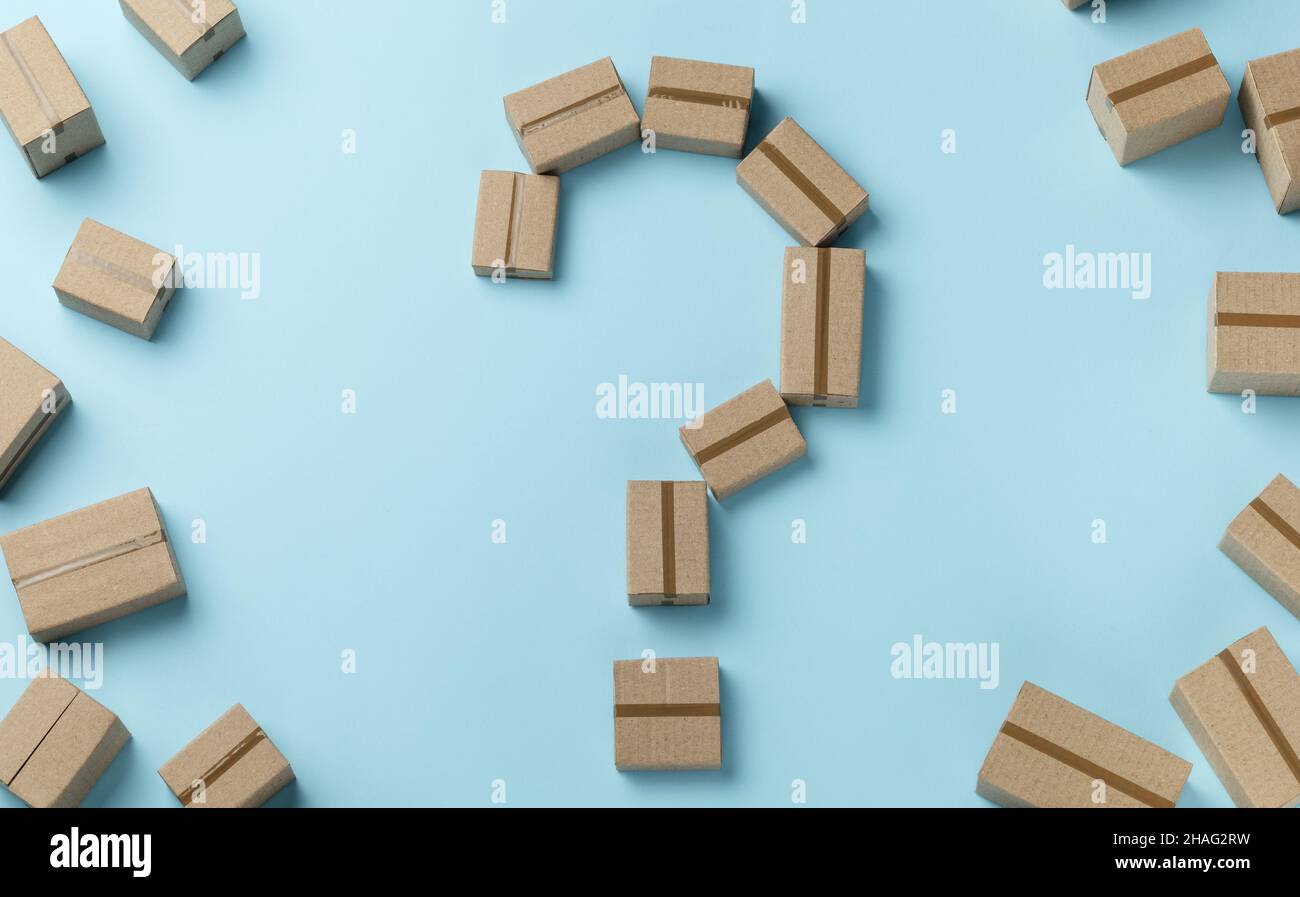 Question mark made from cardboard boxes on a blue background. Delivery ...