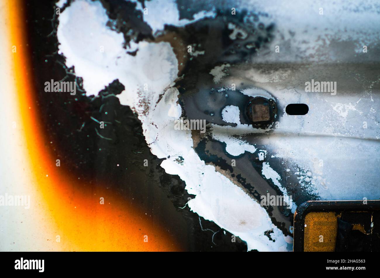 Burned car. abstract close up of the melted parts of a fire damaged ...