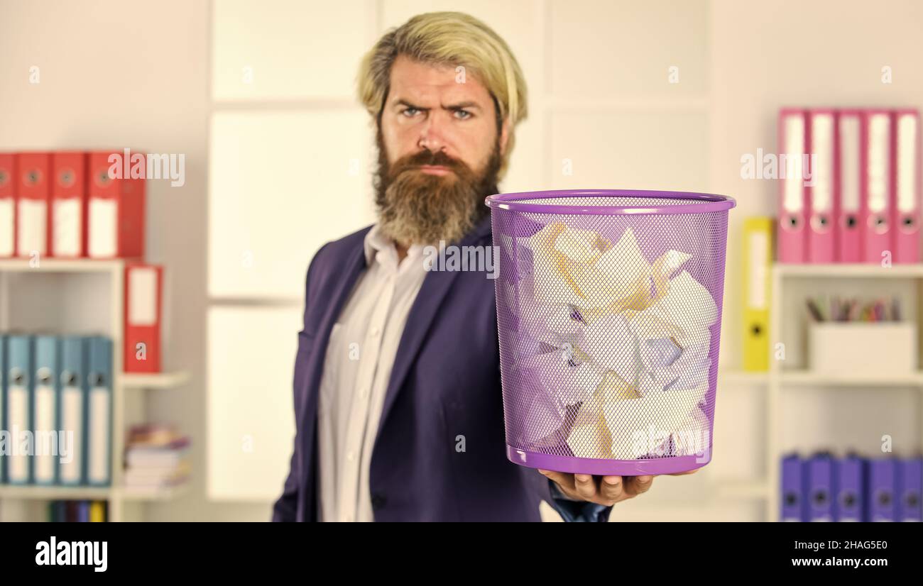 man read piece of paper. office worker digging in garbage bin ...