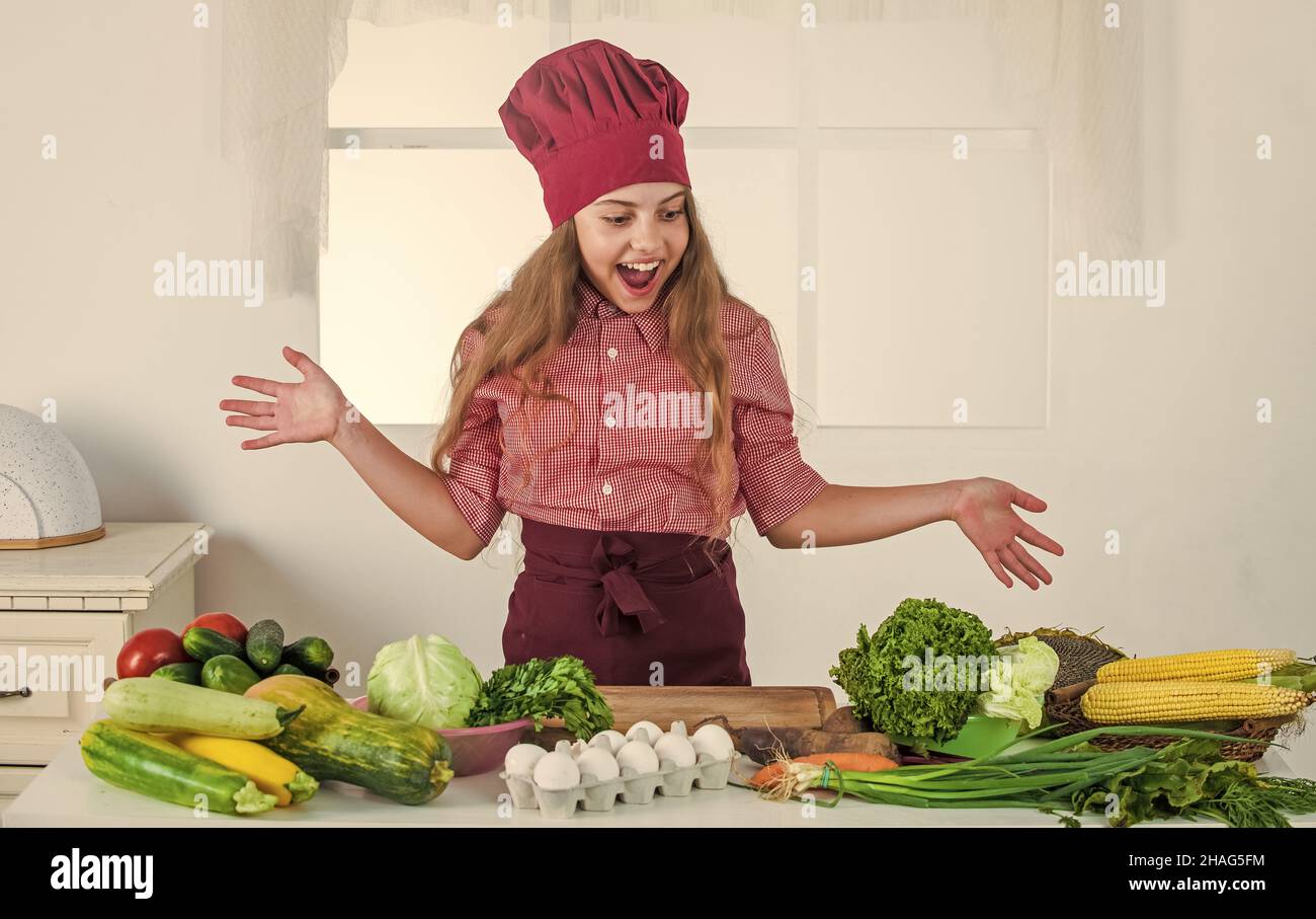 kid having fun with food vegetables at kitchen. Child and vegetables ...