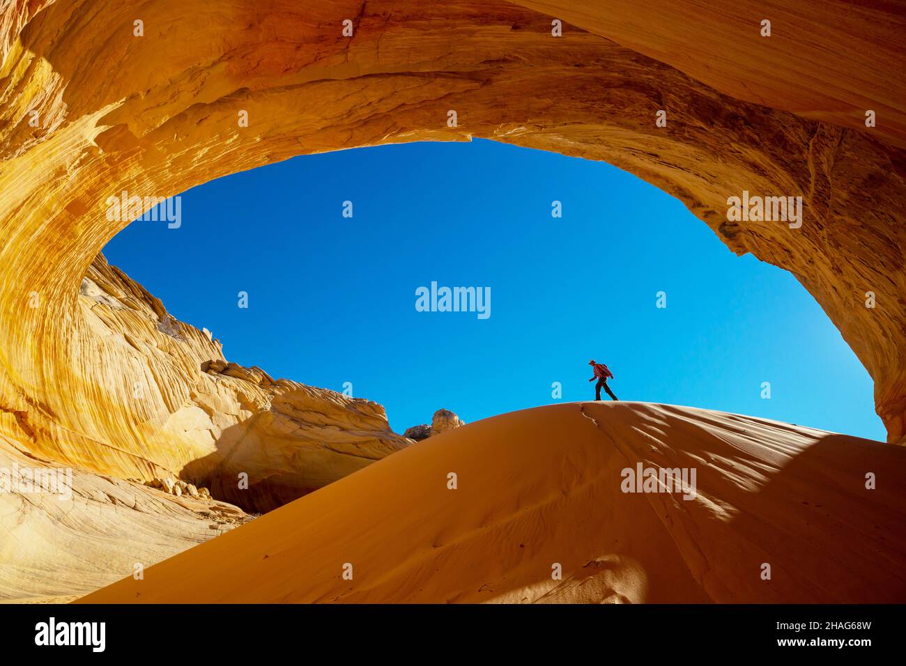 Hiker in the Great Chamber grotto, Utah, USA. Travel and journey scene ...