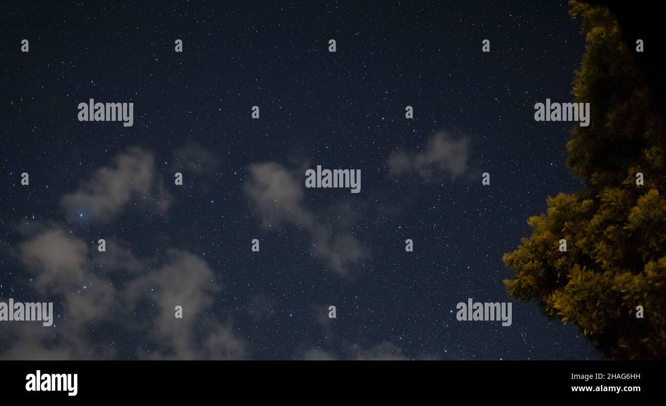 starry night with crisp sky and some clouds with a lot of ...