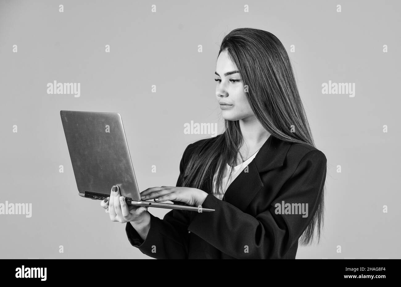 Woman with modern lightweight portable laptop working online, check ...