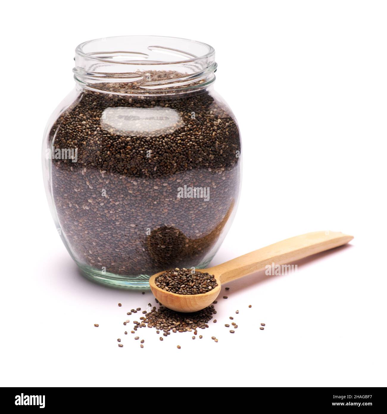 glass can full of organic natural chia seeds close-up isolated on white ...