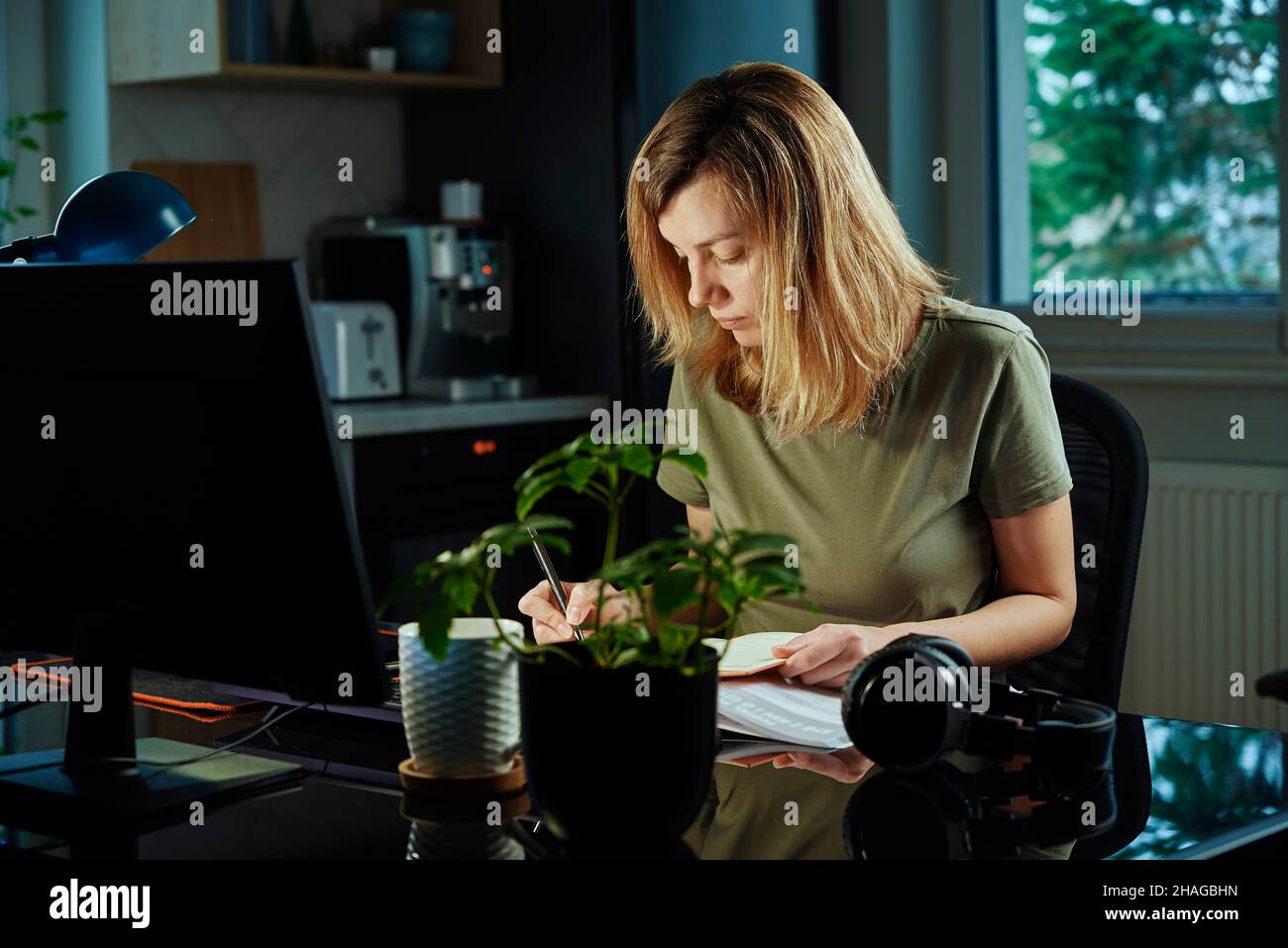 Thirty years old tired man working late remotely at home office, using ...