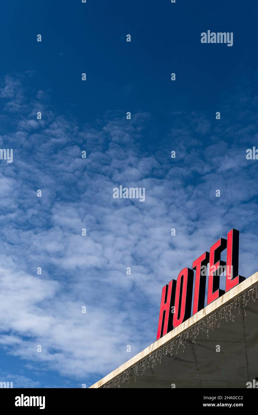 Signboard with giant red letters of hotel with blue sky in the ...