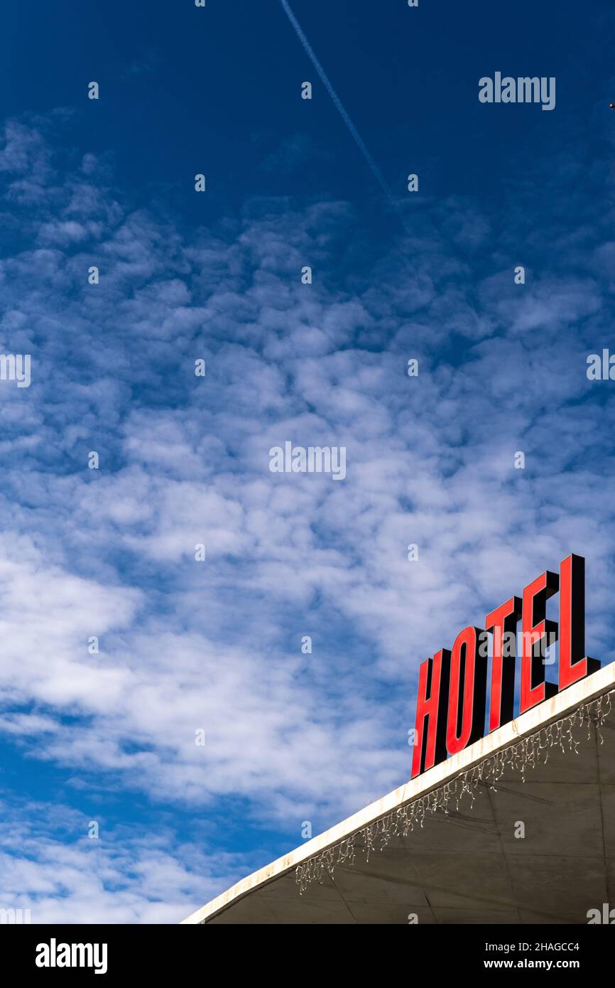 Signboard with giant red letters of hotel with blue sky in the ...