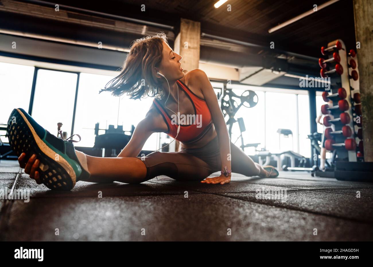 Portrait of happy fit woman exercise in gym to stay healthy Stock Photo ...