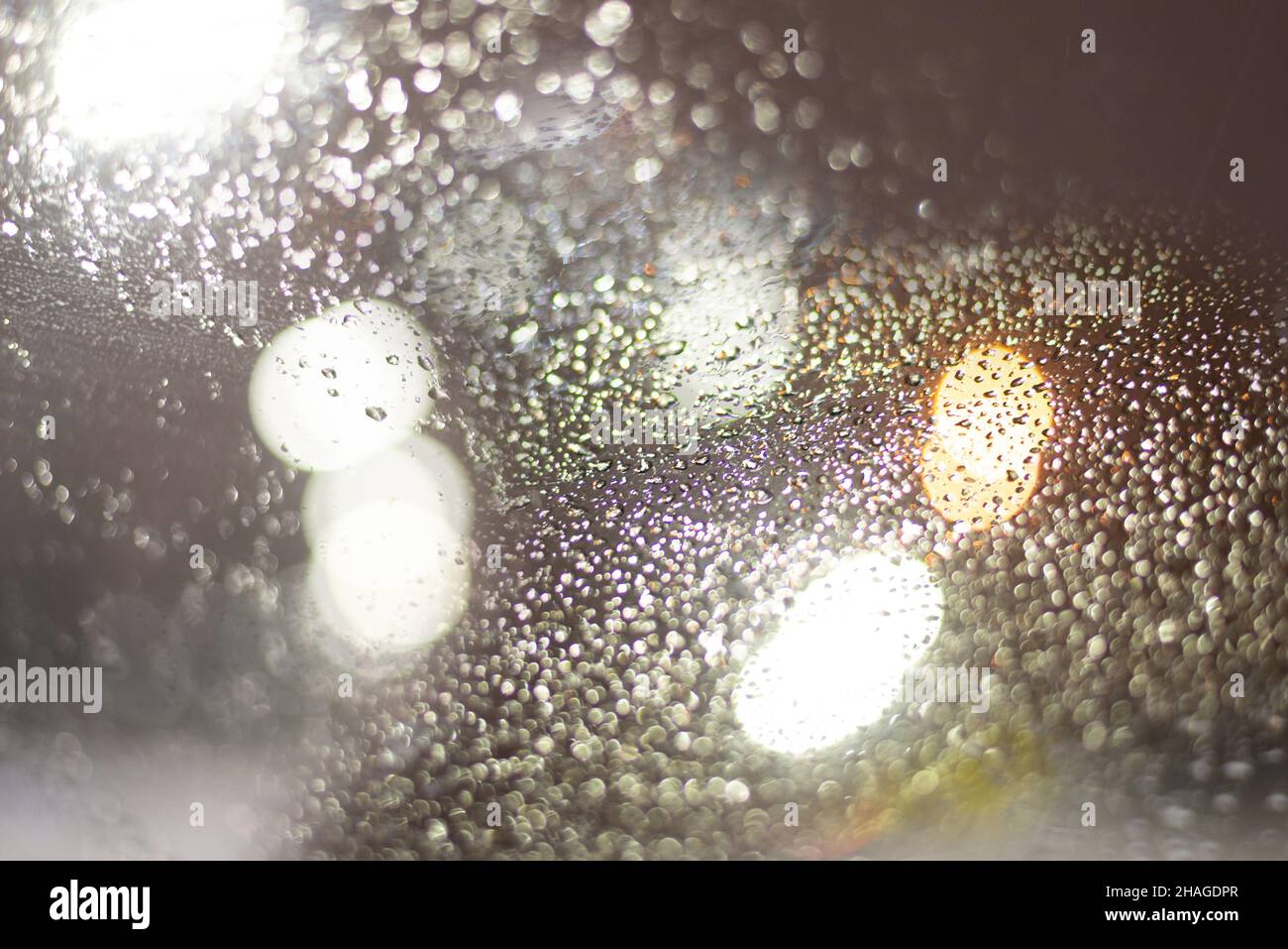 Blurred background with raindrops and lights Stock Photo - Alamy