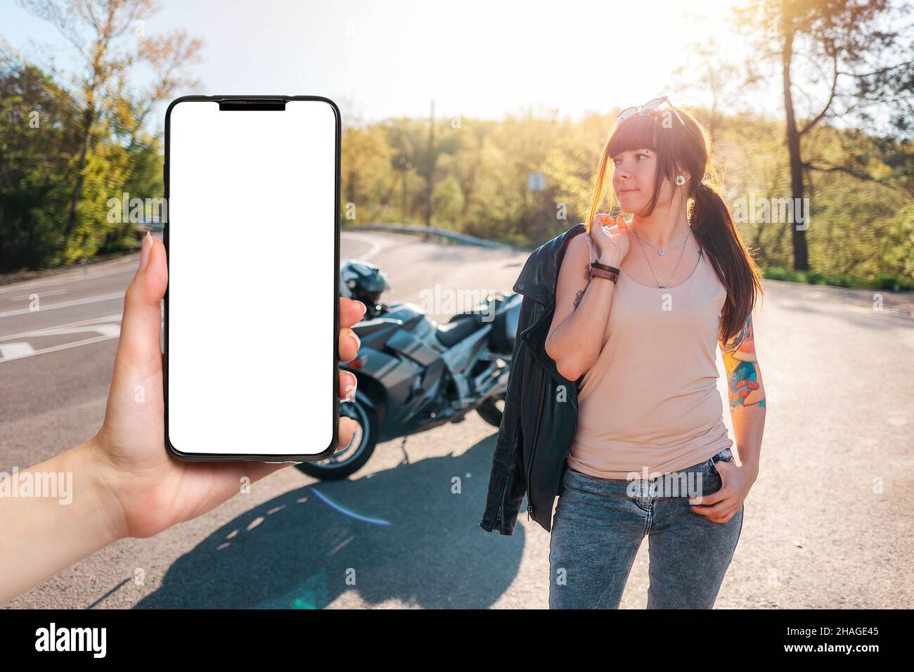 World Motorcyclist Day. A young woman posing against the background of ...