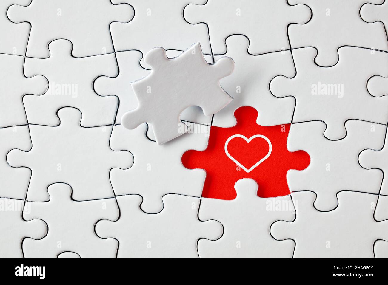 A heart shape on missing puzzle piece. To find love concept Stock Photo ...