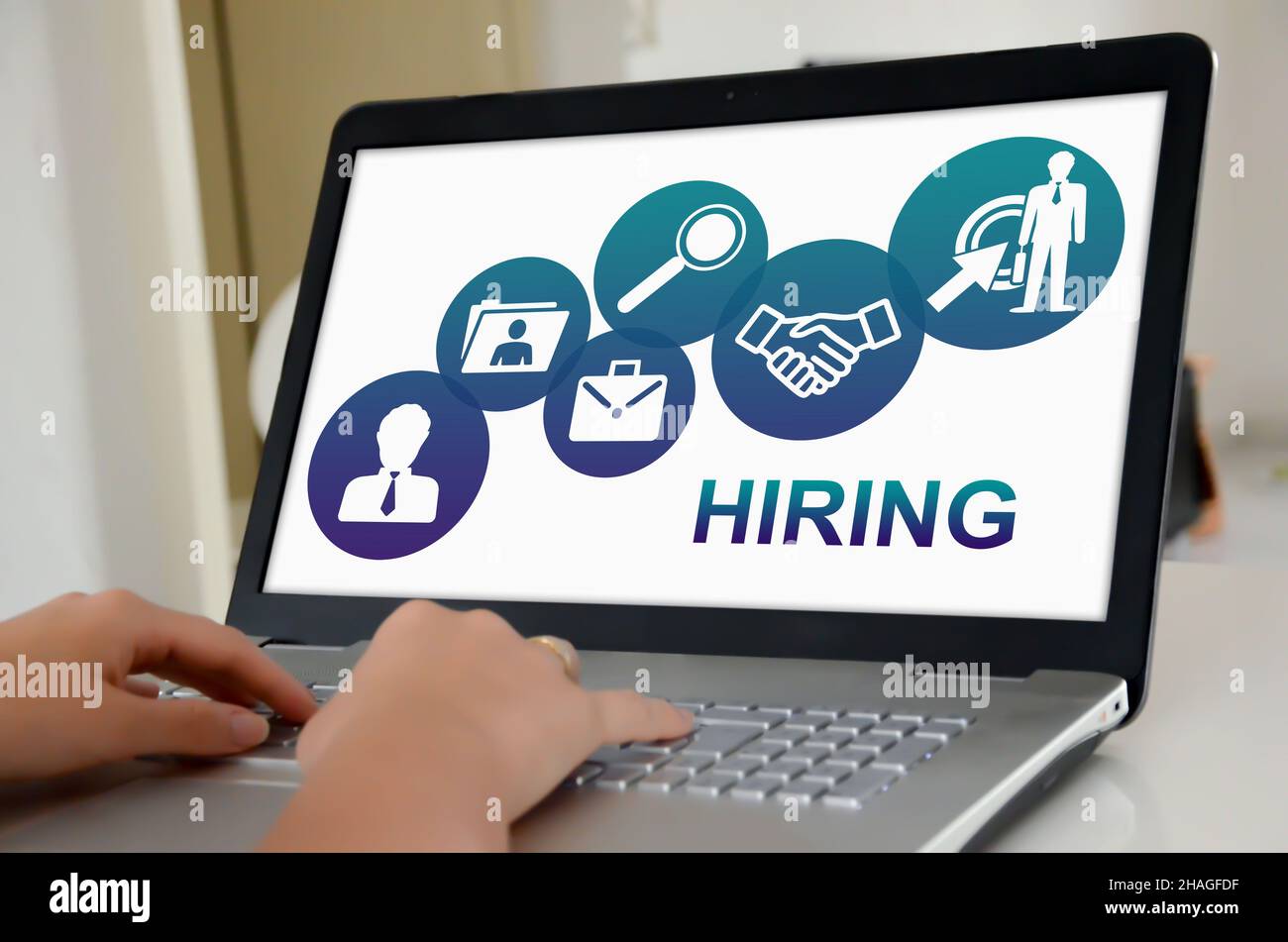 Hands on a laptop with screen showing hiring concept Stock Photo - Alamy