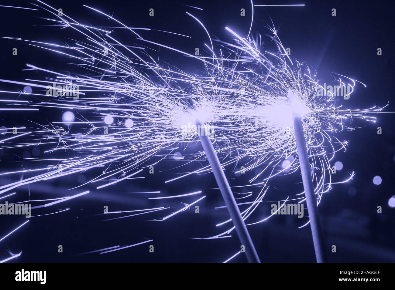 Bright glittering sparkler on blurred bokeh background Stock Photo - Alamy