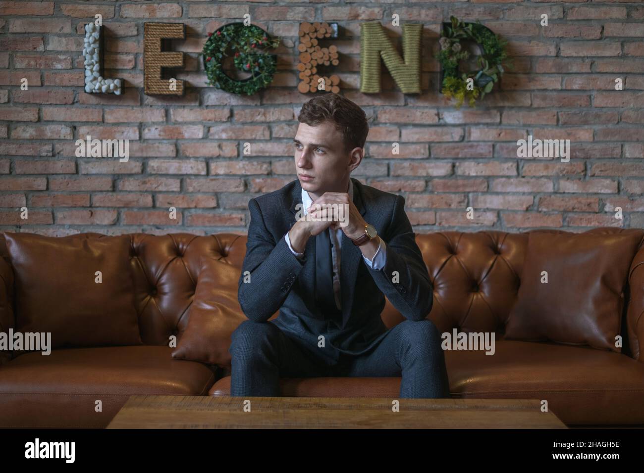Handsome guy in suit sitting hi-res stock photography and images - Alamy