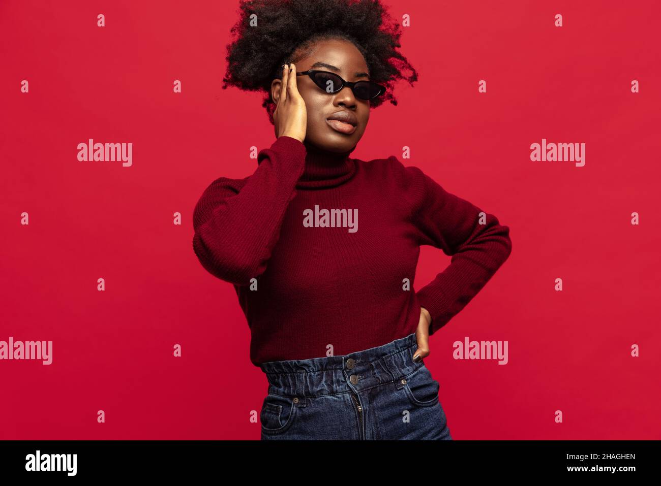 Studio shot of young beautiful dark skinned girl in eyeglasses isolated ...