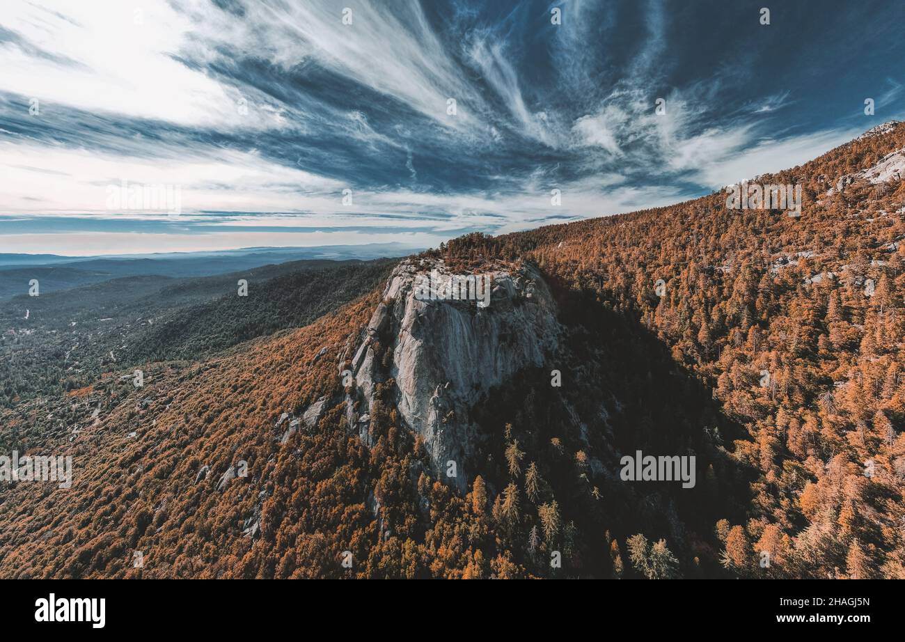 Mountain peak surrounded by forest with big blue sky Stock Photo - Alamy