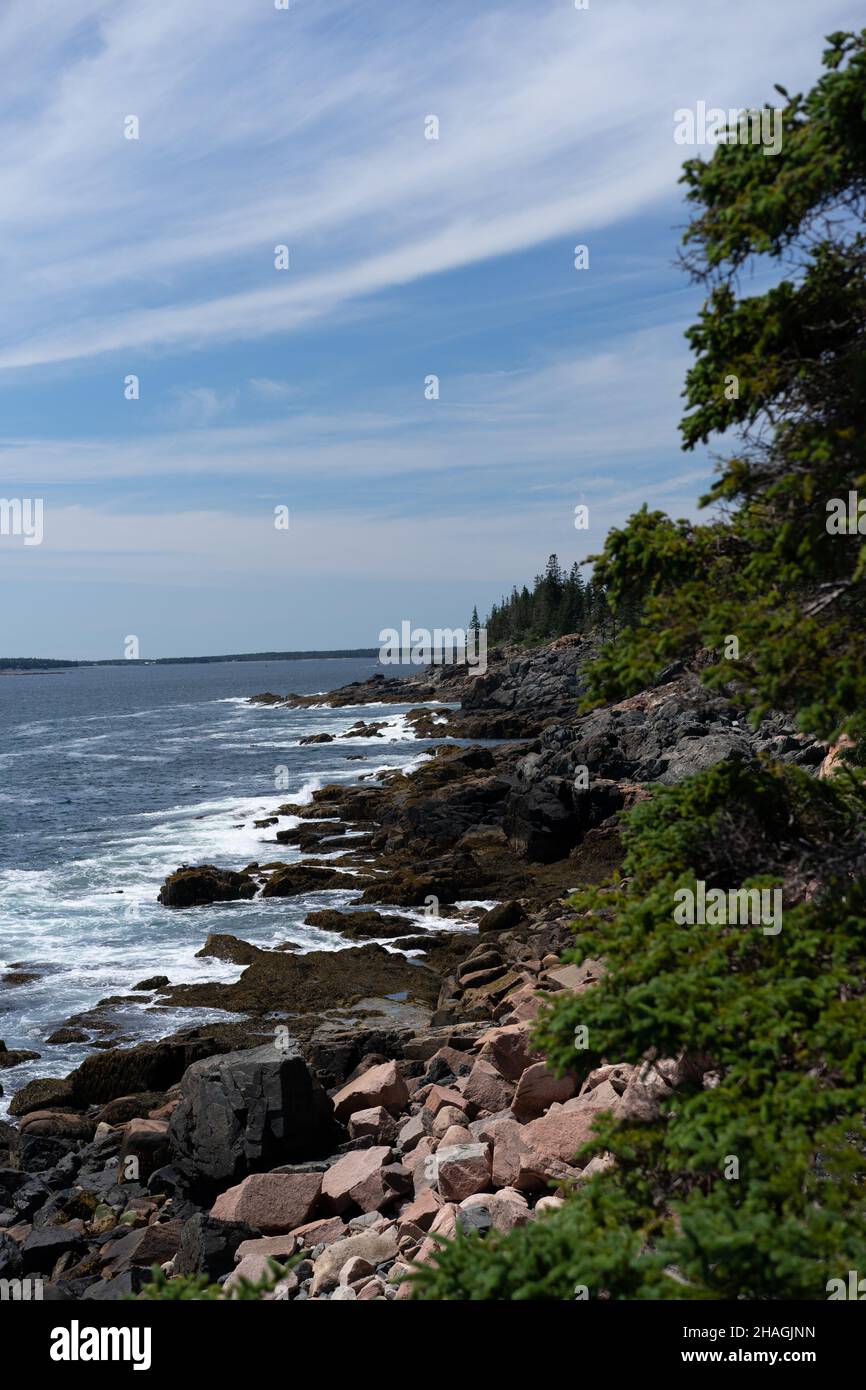 Vertical shot of the ocean surrounded by a rocky shore in Acadia ...